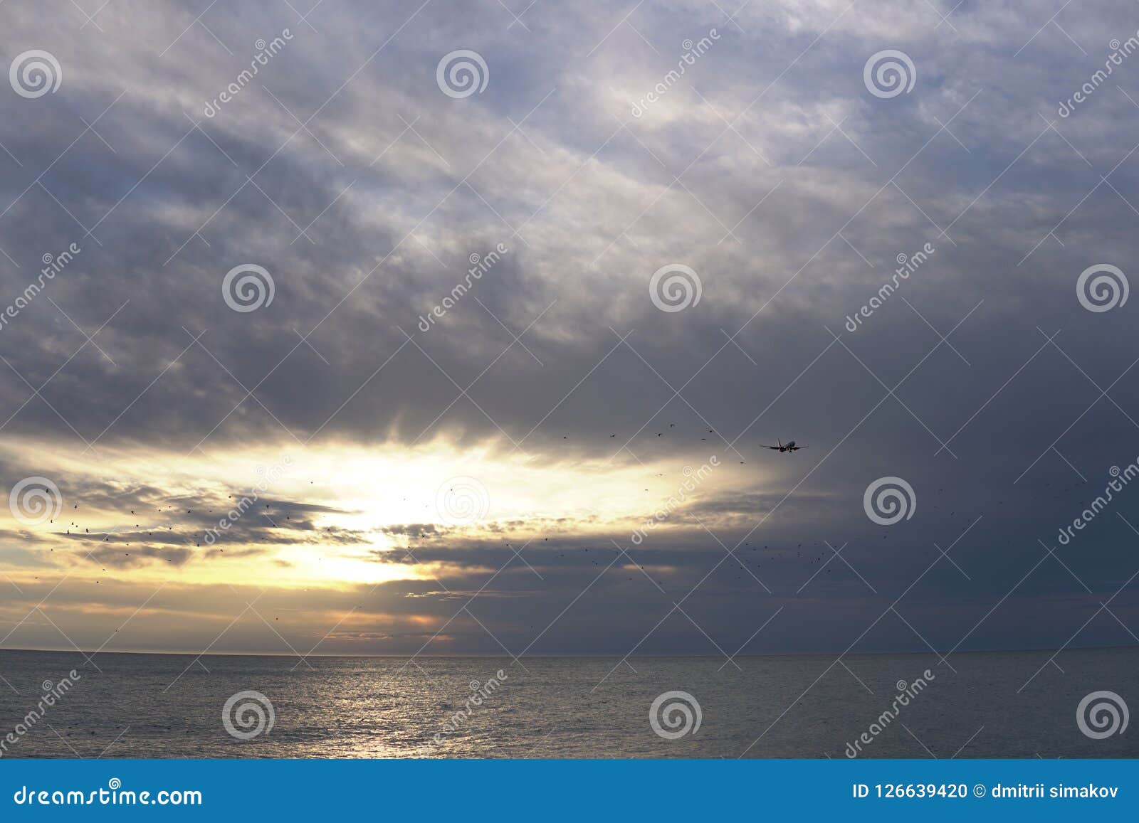A Passenger Plane Flying in the Sky Over the Sea V Stock Photo - Image ...