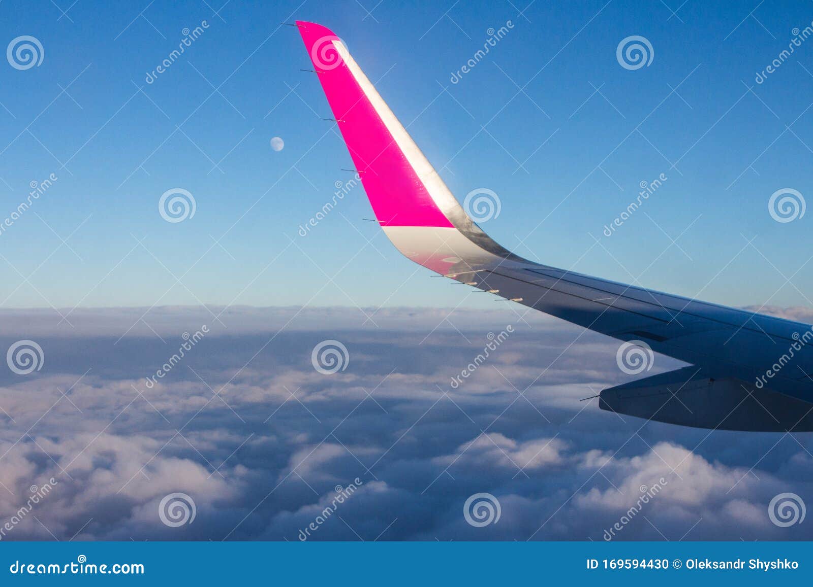 Passenger Plane Wing in the Sky Above the Clouds. Round Moon on the ...