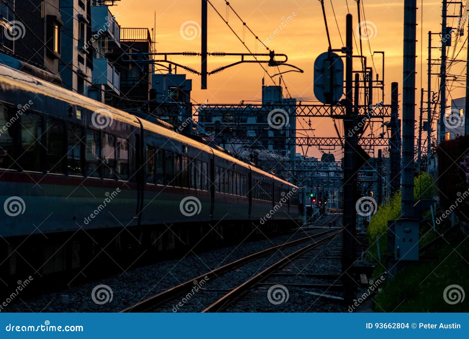 A Passenger Train Departing into a Sunset in Tokyo. Stock Photo - Image ...