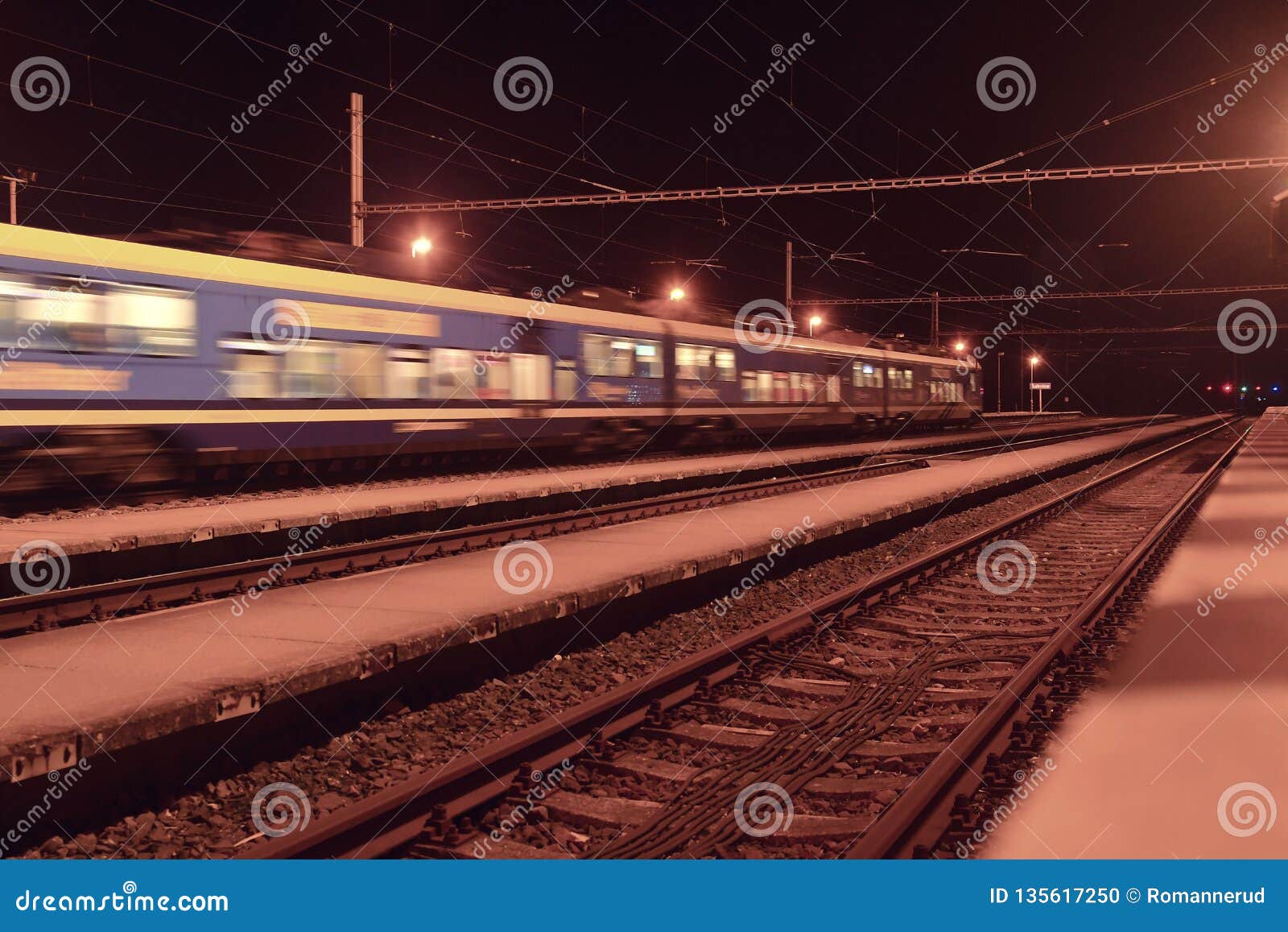 Passenger Train on Railroad Tracks at Night Blurred Motion Stock Photo ...