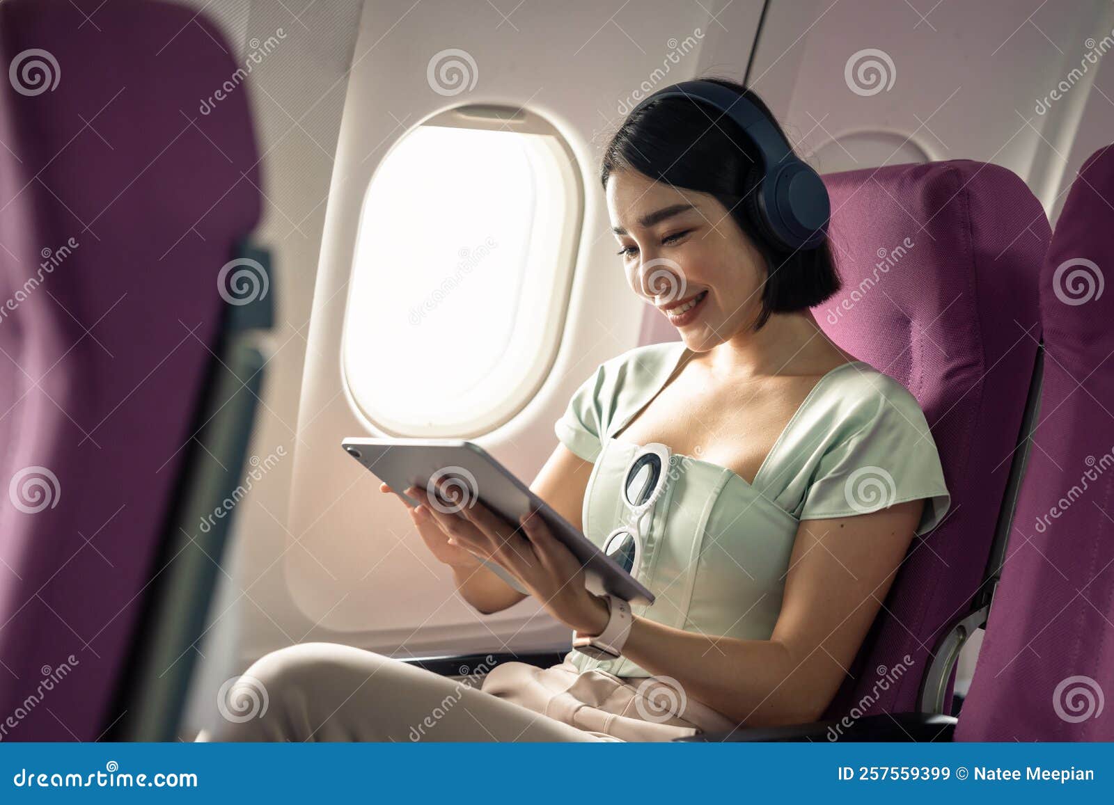 Passenger Using Tablet Computer in Airplane Cabin during Flight ...