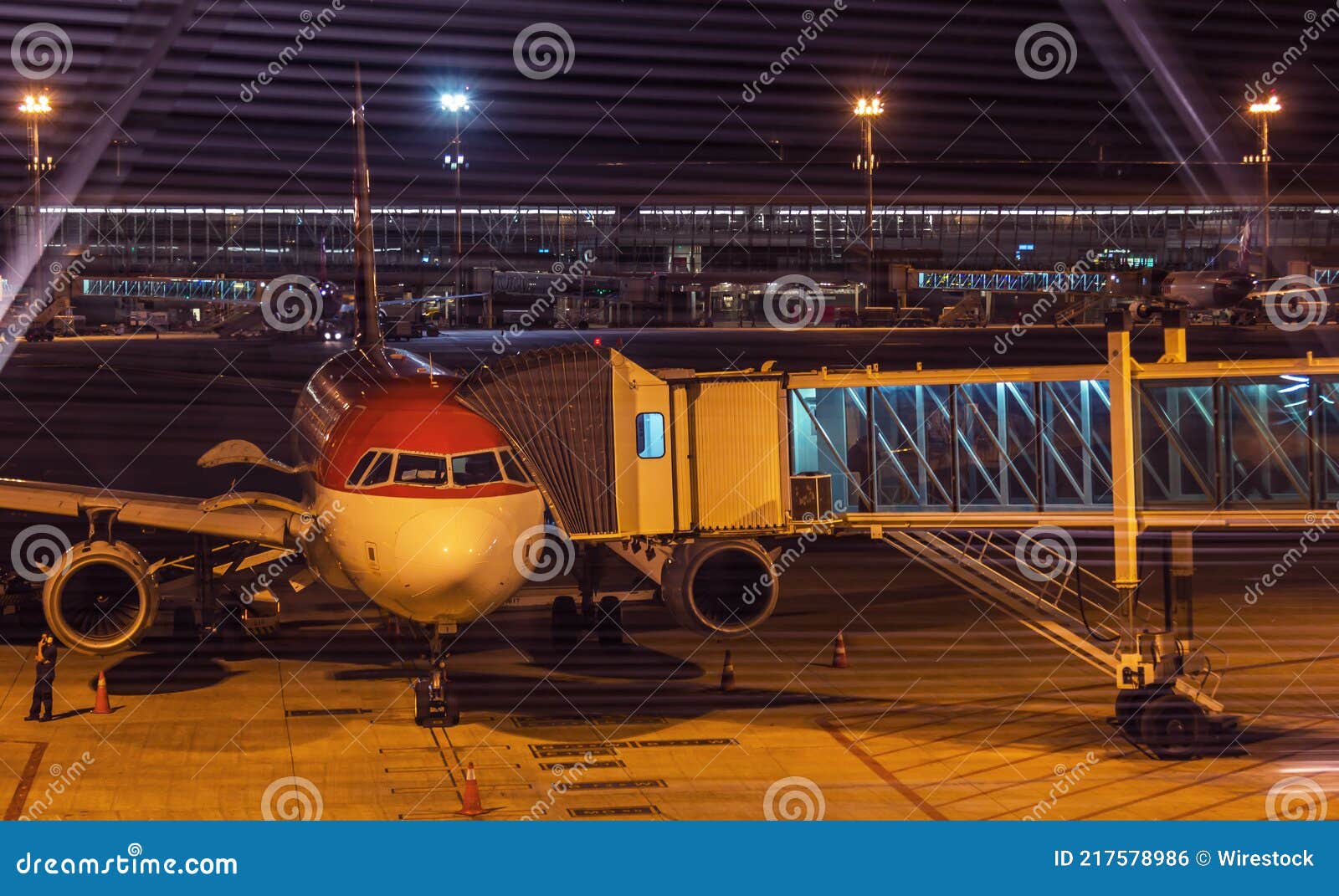 Passengers Getting Out of a Plane through a Jet Bridge at Night Stock ...
