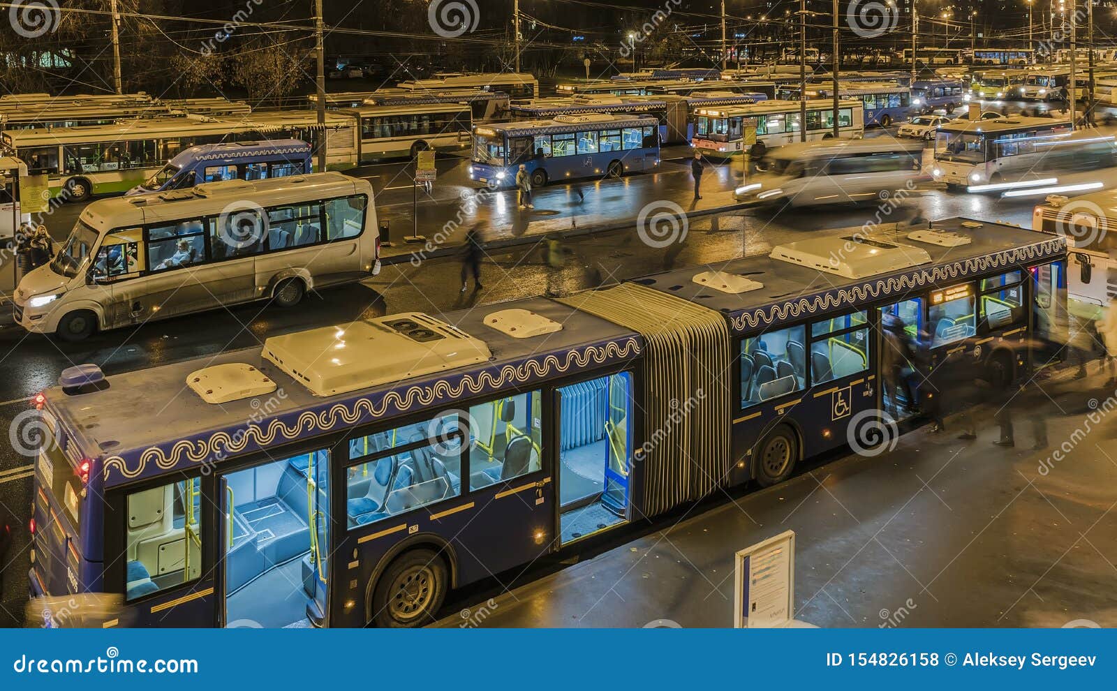 Passengers Waiting and Boarding Buses at the Bus Terminal Stock Photo ...