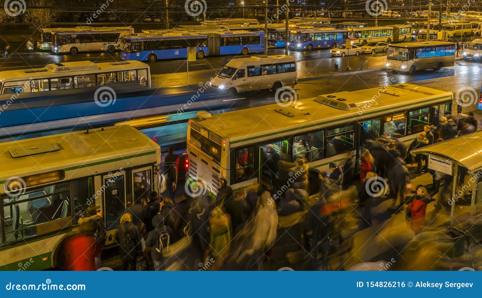 Passengers Waiting and Boarding Buses at the Bus Terminal Stock Photo ...