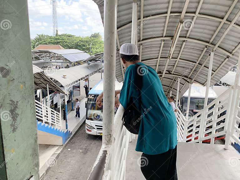 Passengers Waiting for the Bus at the Pool during Idul Fitri at the ... Passengers Waiting for the Bus at the Pool during Idul Fitri at the ...
