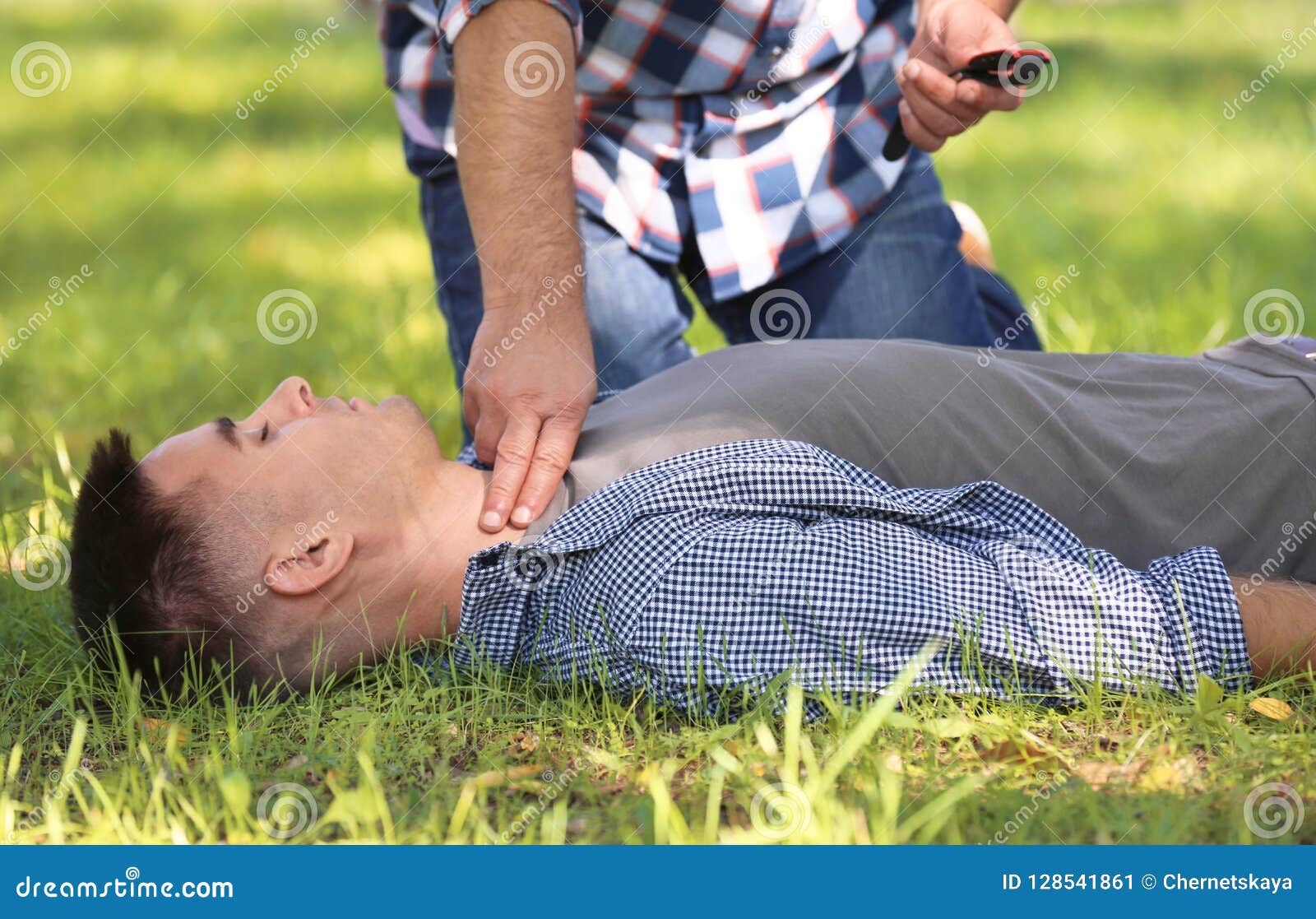 Passerby Calling Ambulance while Checking Pulse Stock Image - Image of ...
