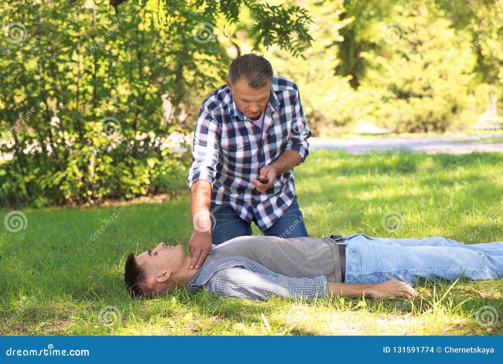 Passerby Calling Ambulance while Checking Pulse of Unconscious Man ...