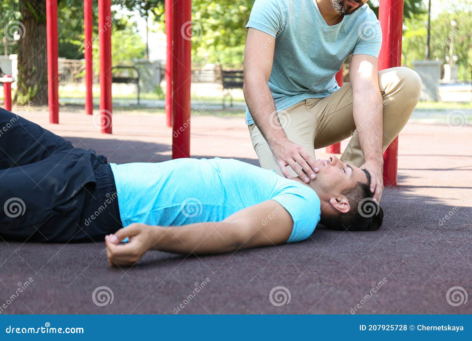 Passerby Giving First Aid To Unconscious Man Outdoors Stock Photo ...