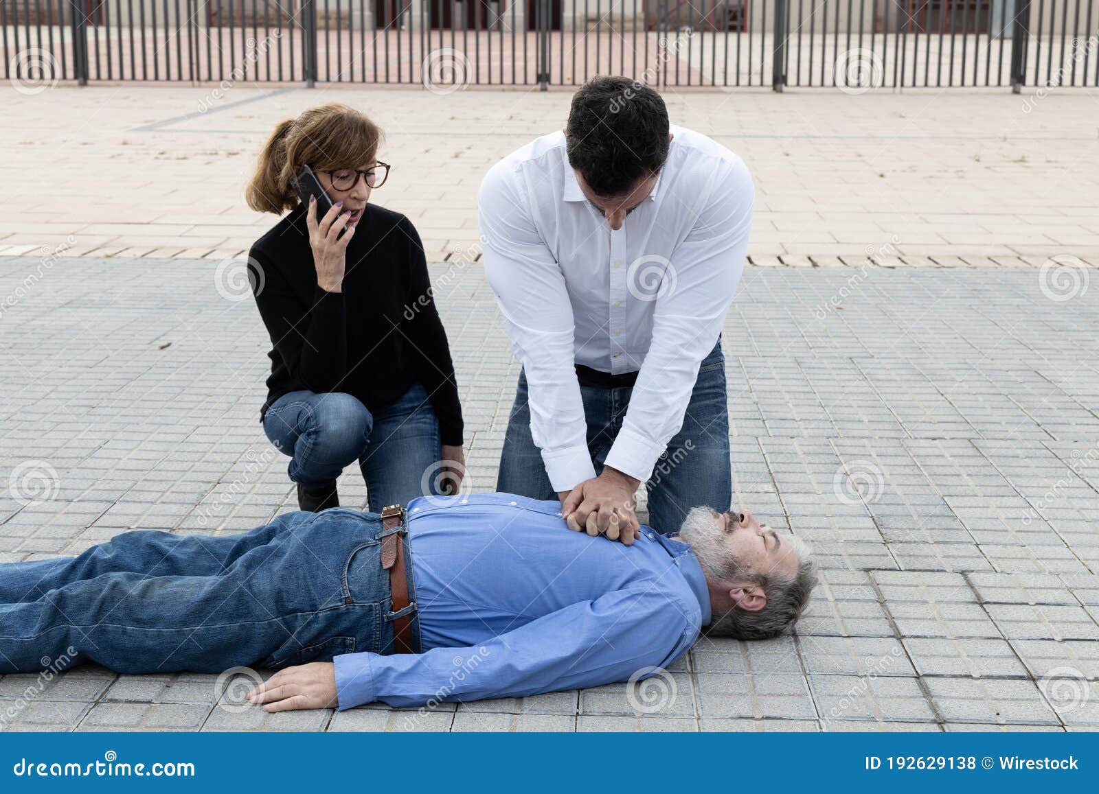 Passers Helping an Unconscious Man Outdoors - First Aid Concept Stock ...