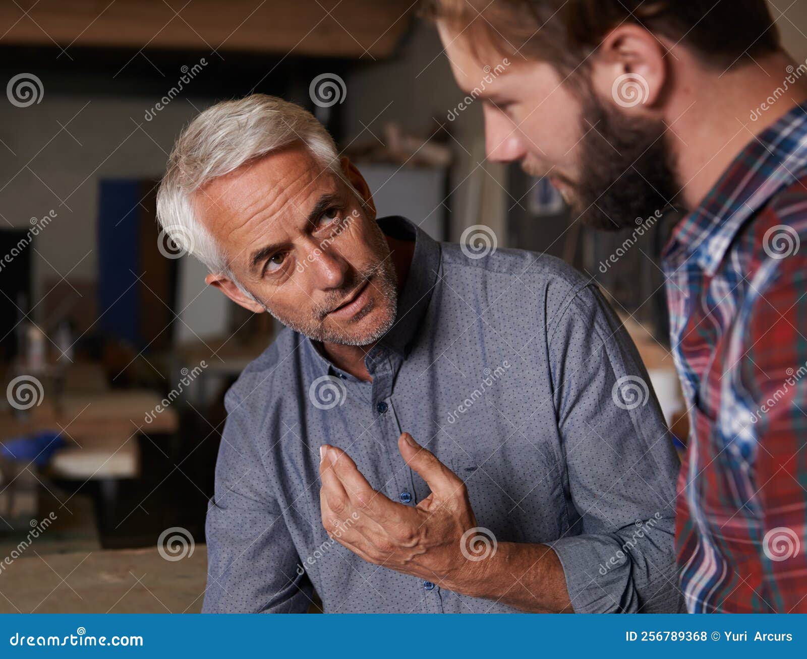Passing on All His Knowledge. an Older Man Standing Indoors Giving His ...