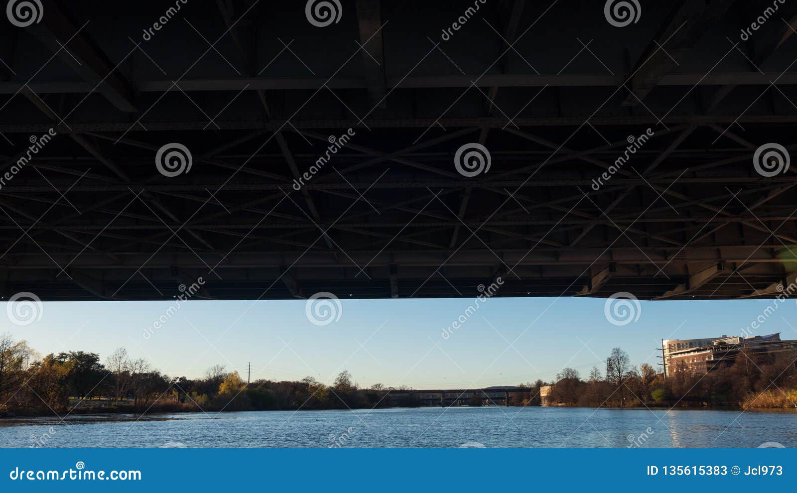Passing on a Boat Underneath a Bridge that Spans a River Stock Image ...
