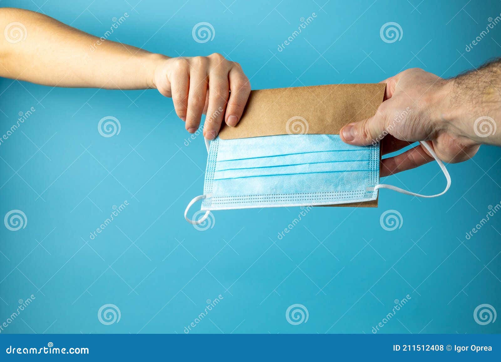 Passing an Envelope from Hand To Hand on Blue Background Copy Space ...
