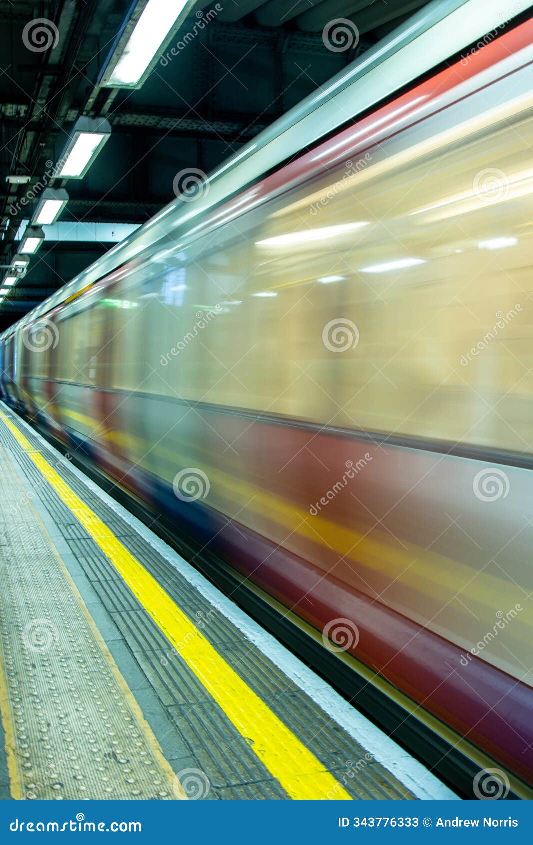 A Passing High Speed Passenger Train Flying Past a Train Station ...