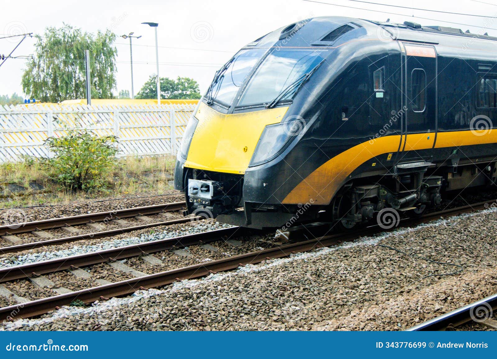 A Passing High Speed Passenger Train Flying Past a Train Station ...
