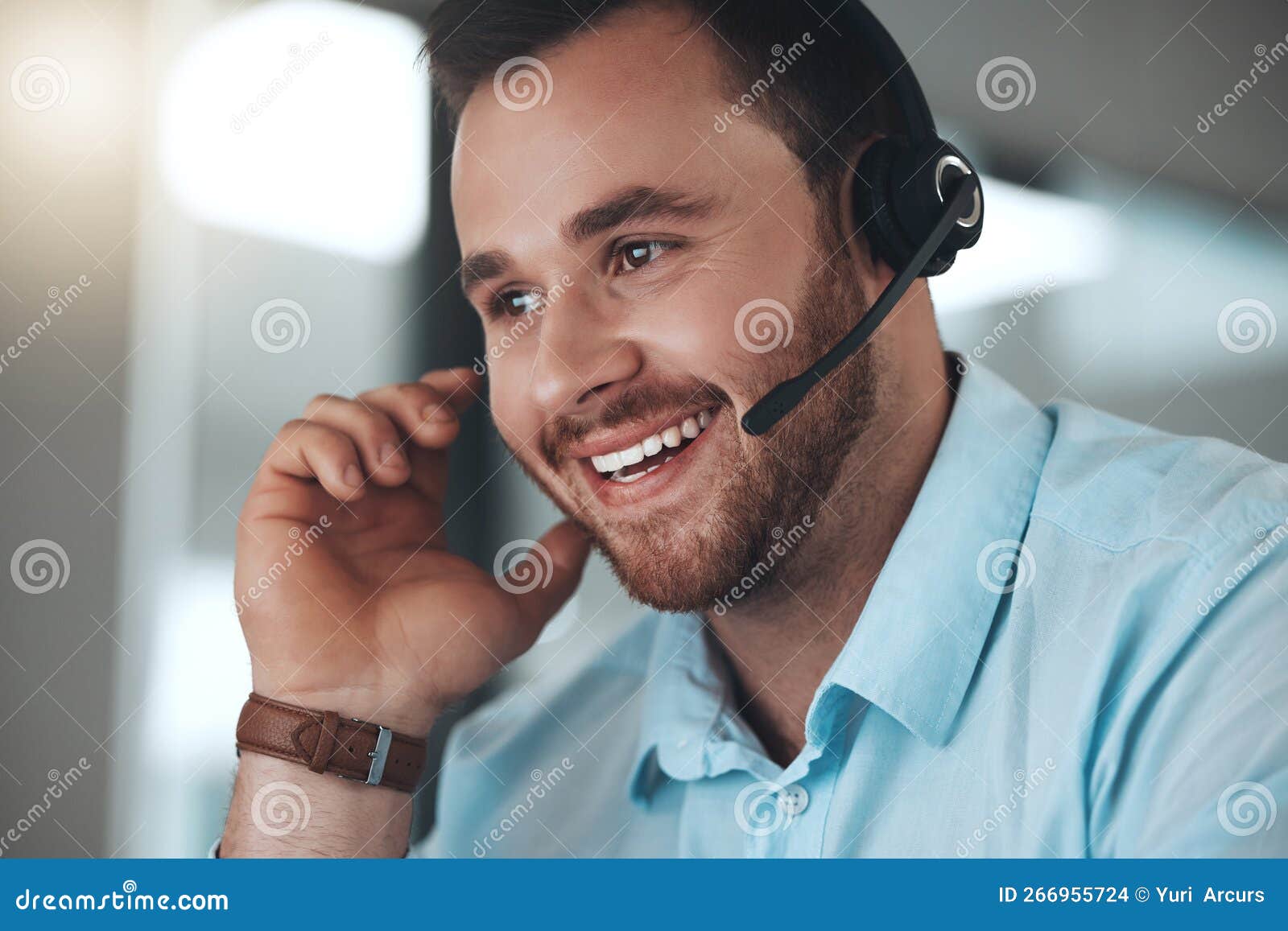 Passing Positivity Onto the Client. a Young Call Centre Agent Sitting ...
