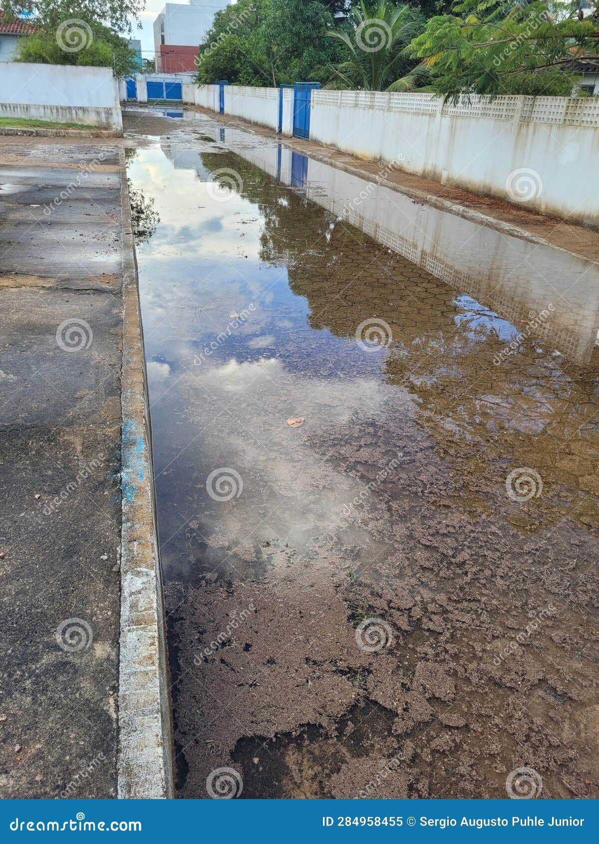 Passing Rain: Reflections of Water Puddles in the Condominium Stock ...