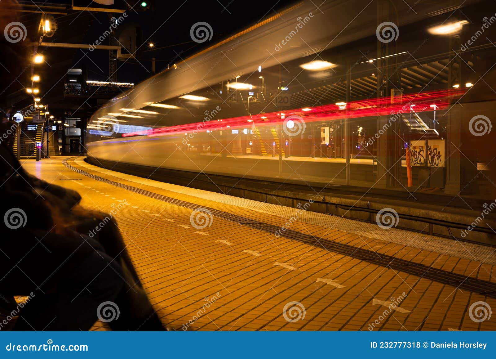Passing Train Leaving Light Trail in the Train Station Stock Photo ...