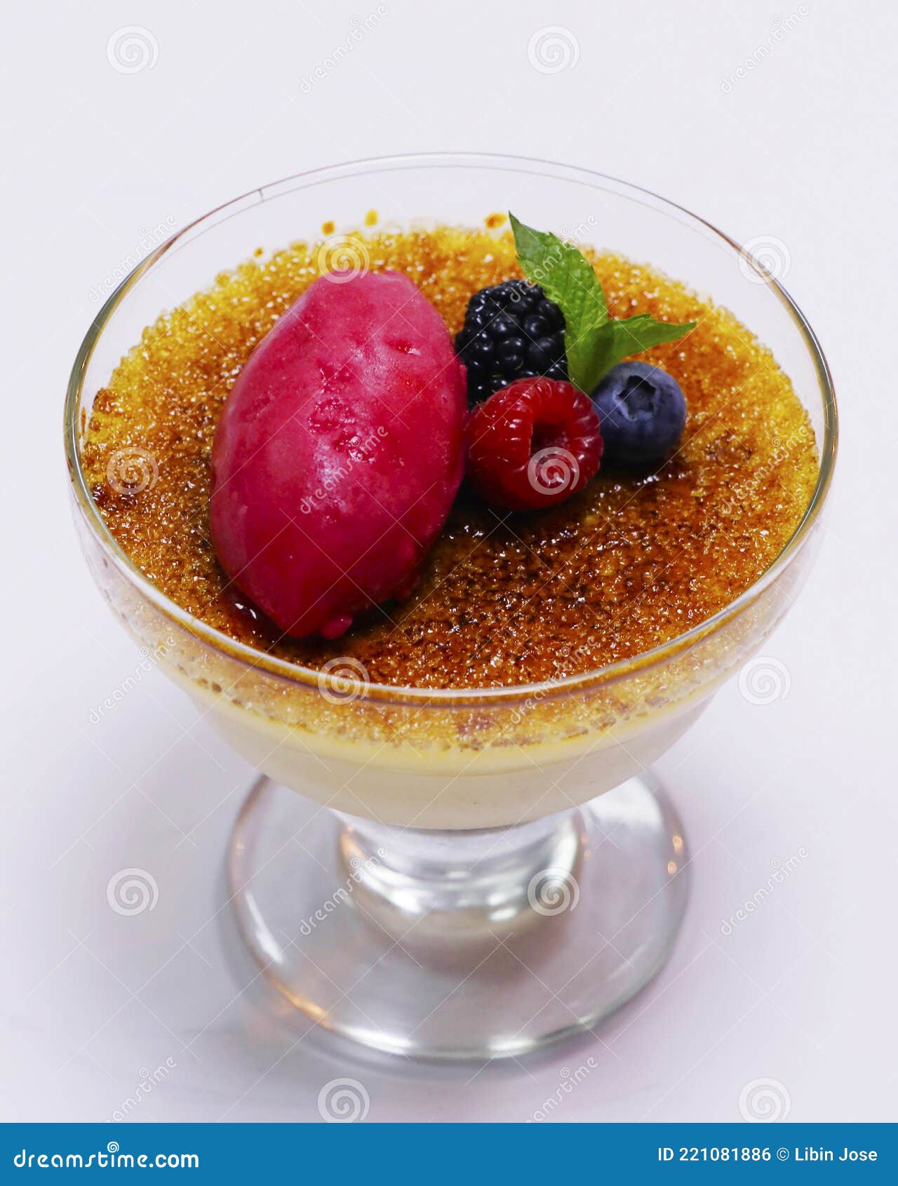 Passion Creme Brulee with Raspberry Sorbet and Berries Stock Photo ...