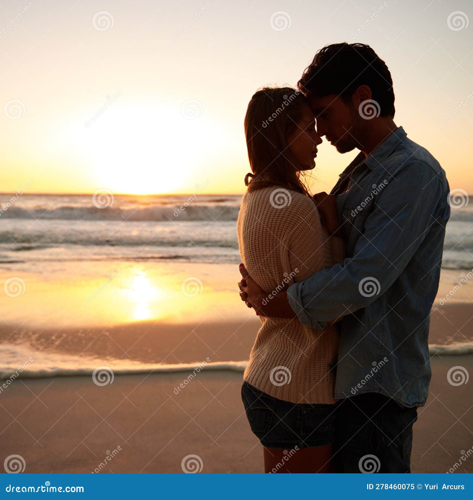 Passion At Sunset A Loving Young Couple Embracing On The Beach At