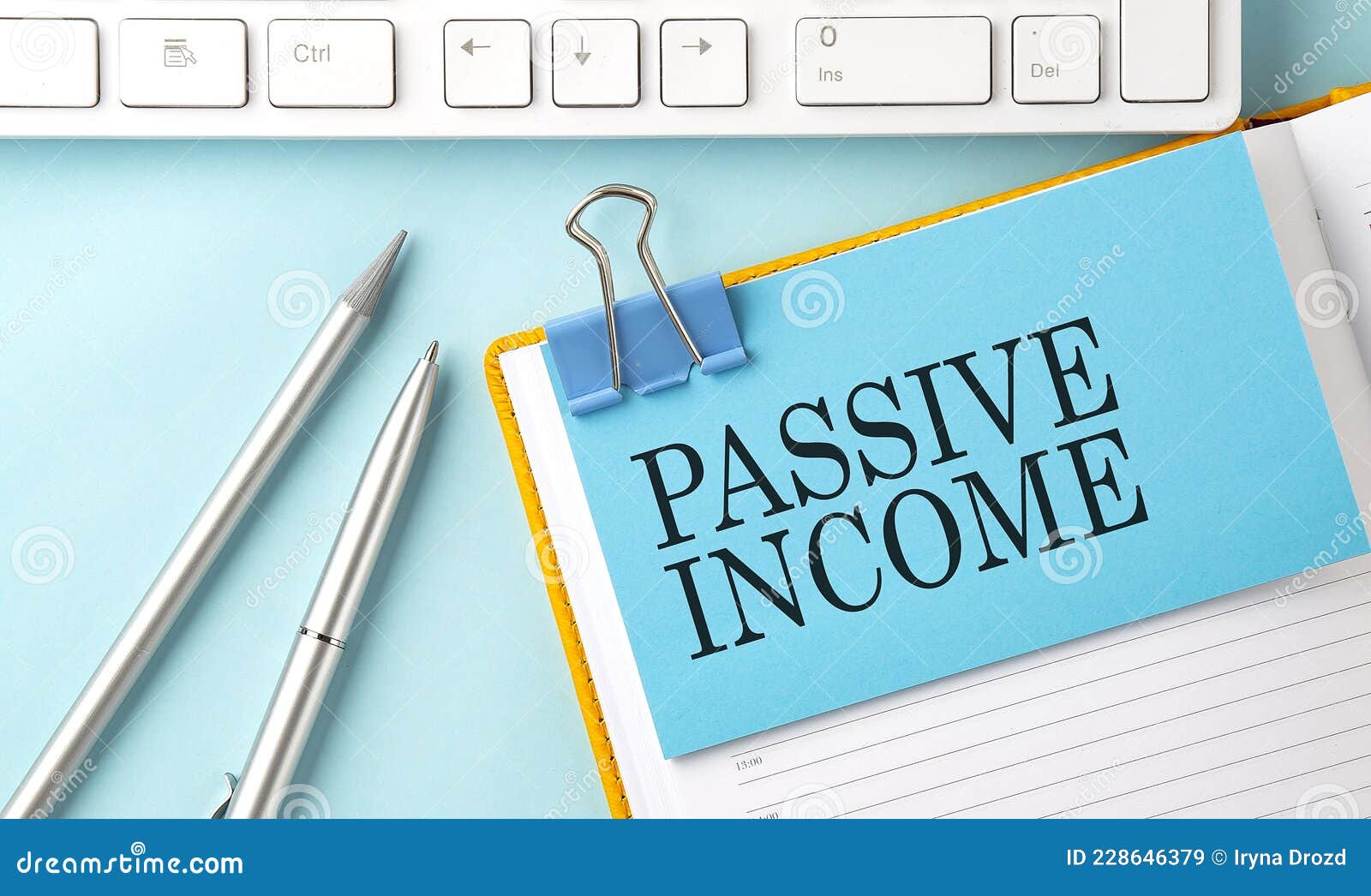 PASSIVE INCOME Text on Sticker on the Blue Background with Pen and ...