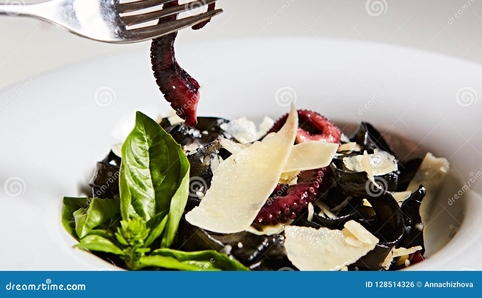 Pasta with Black Cuttlefish Ink, Octopuses and Parmesan. Stock Photo ...