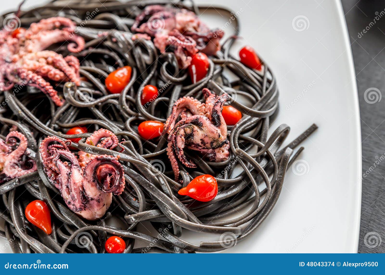 Pasta with Black Cuttlefish Ink and Small Octopuses Stock Photo - Image ...