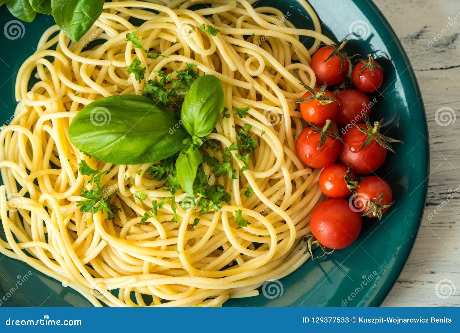 Pasta with Herbs, Basil and Tomatos Served on Green Pate Stock Image ...