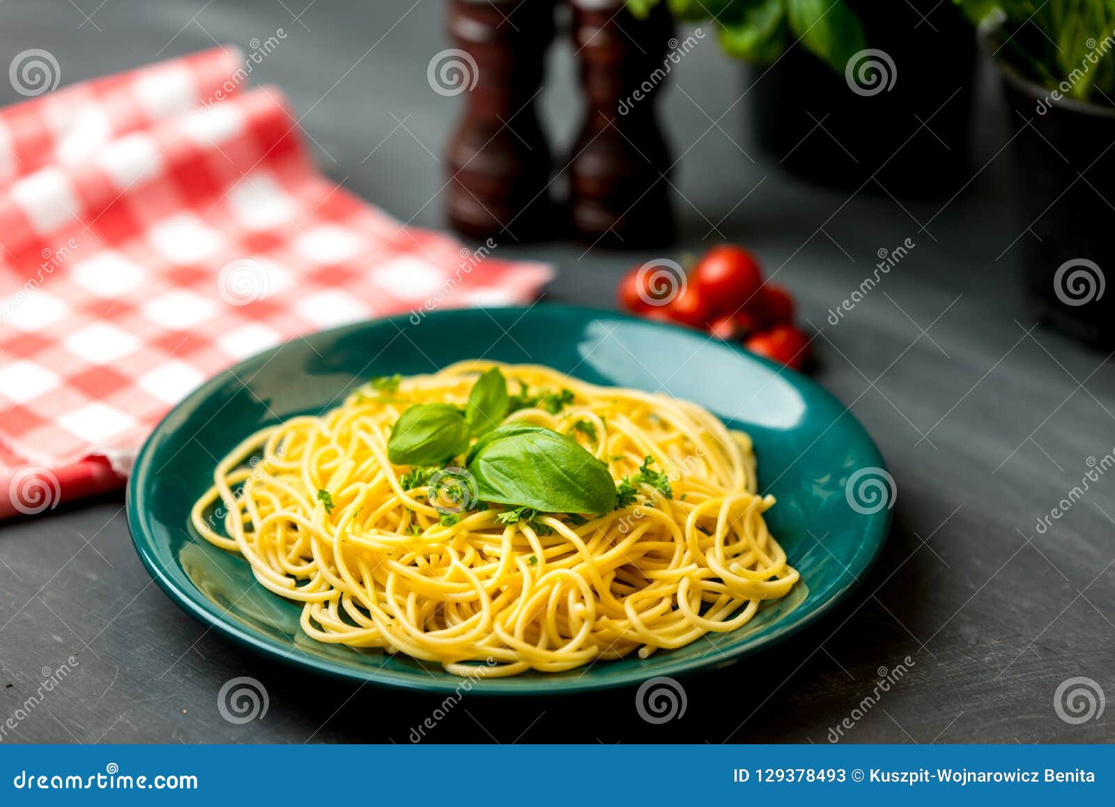 Pasta with Herbs, Basil and Tomatos Served on Green Pate Stock Image ...