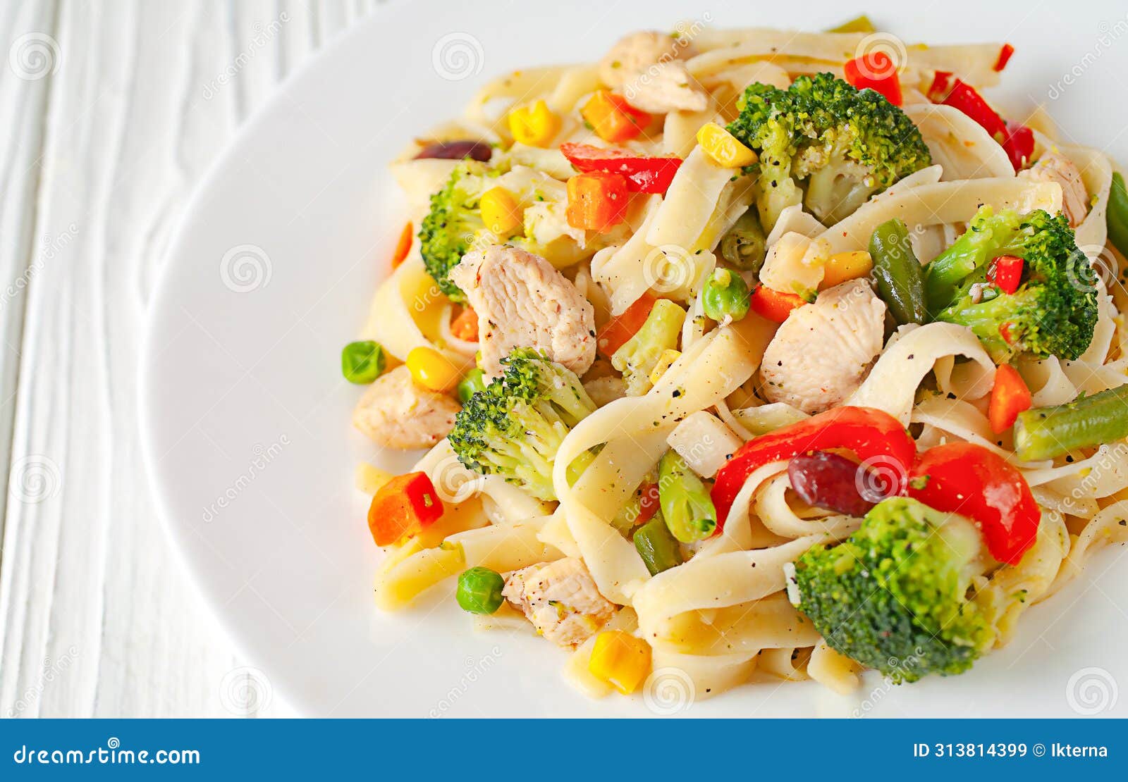 Pasta with Vegetables on a Plate Against a Brick Wall Background Stock ...