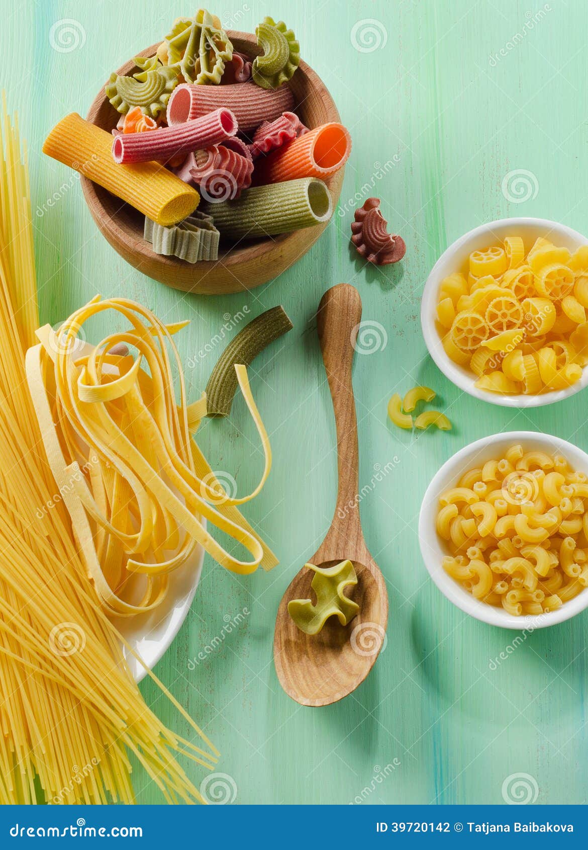 Pasta on a wooden table stock photo. Image of bunch, cooking - 39720142