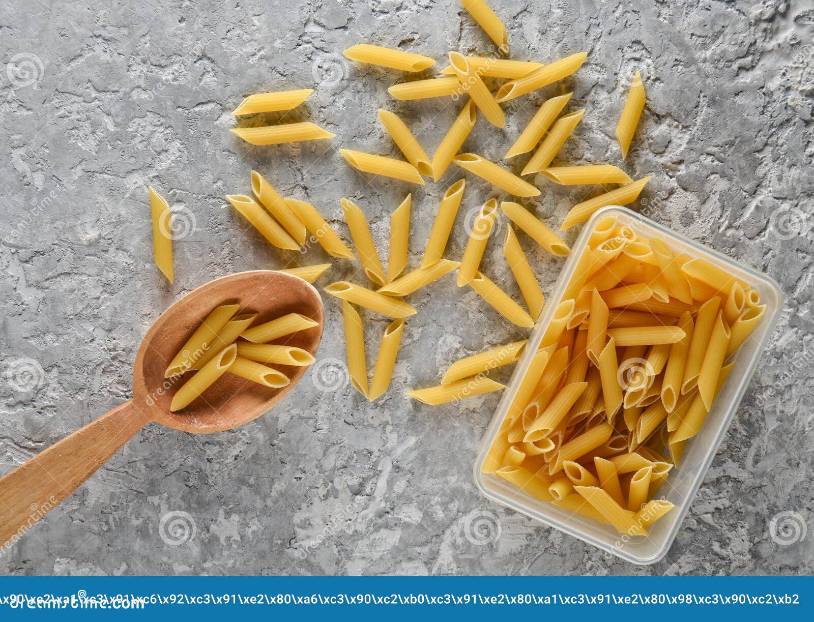 Paste in a Wooden Spoon and in a Container on a Gray Concrete Table ...