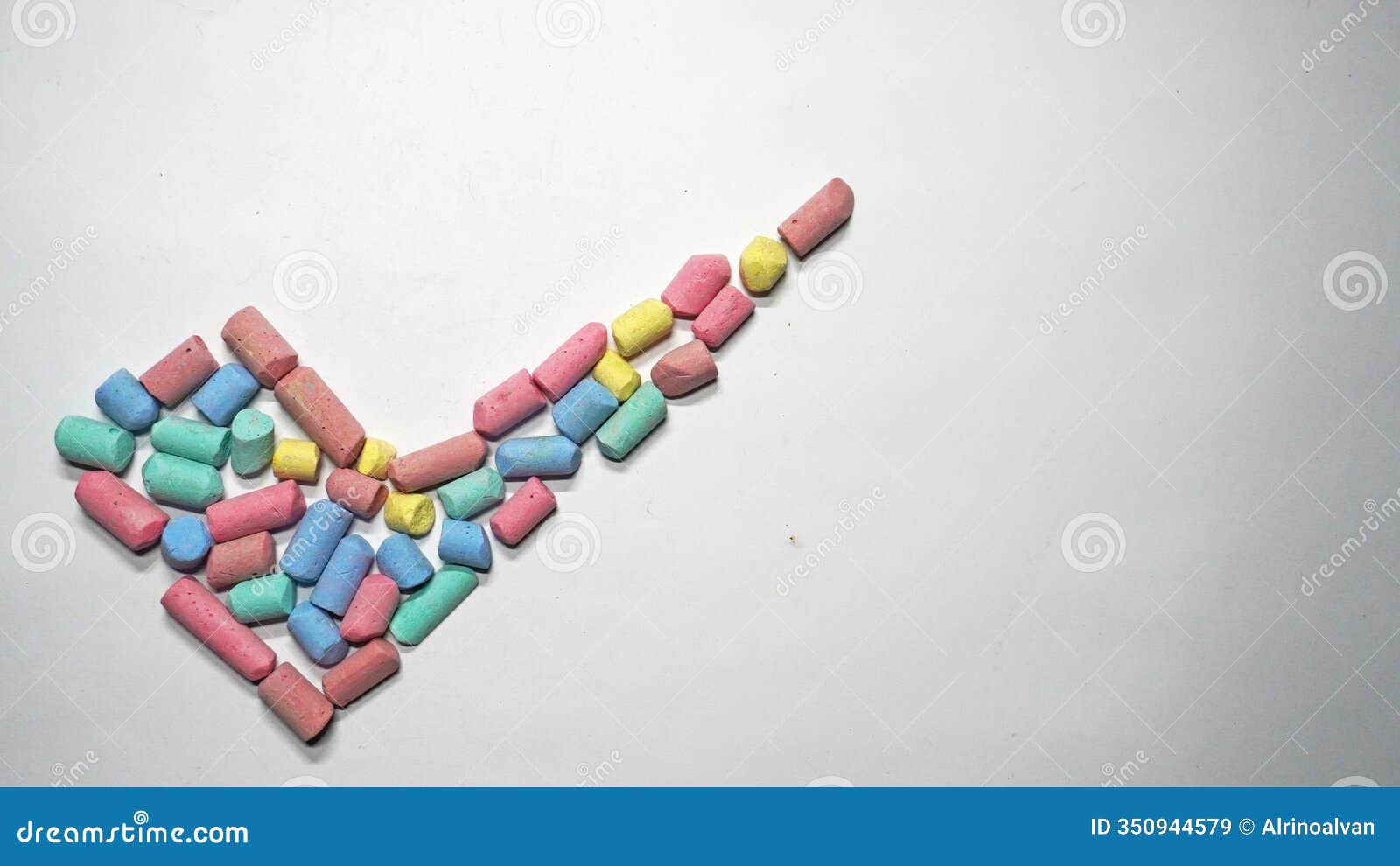 Colorful Chalk Shaped into a Checkmark on White Background Symbolizing ...