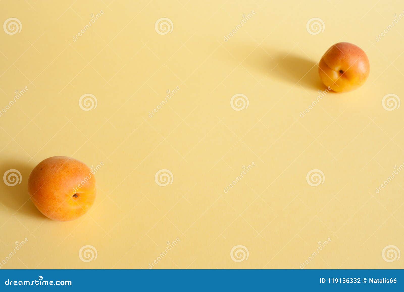 Pastel Yellow Background with Two Apricots. Stock Photo - Image of ...