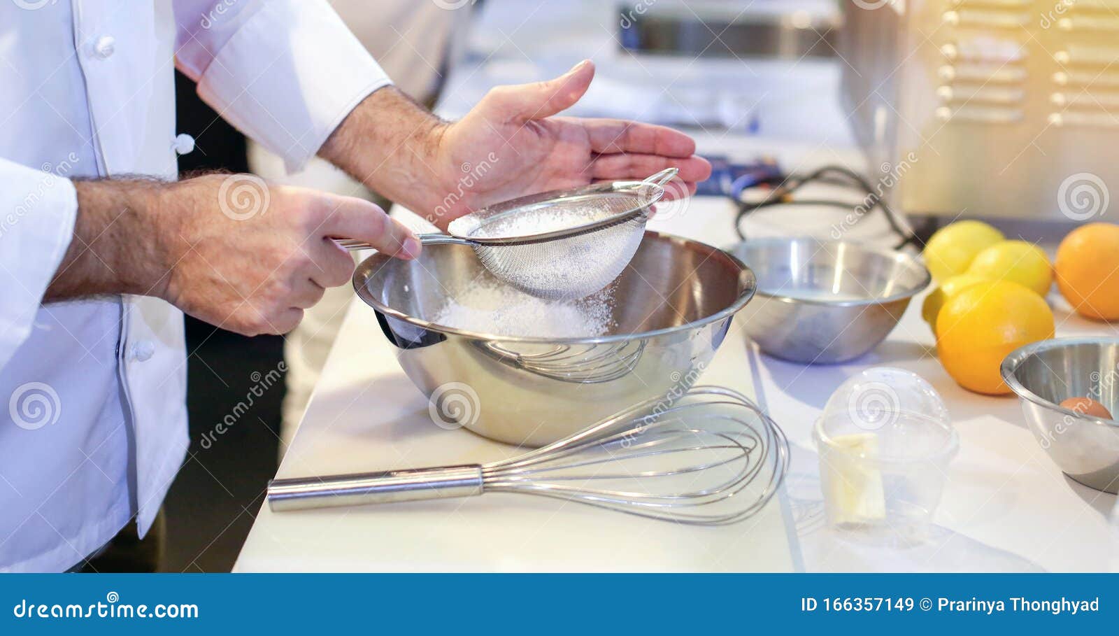 Pastry Chef Baker Sieving Flour into a Bowl in the Kitchen of the ...