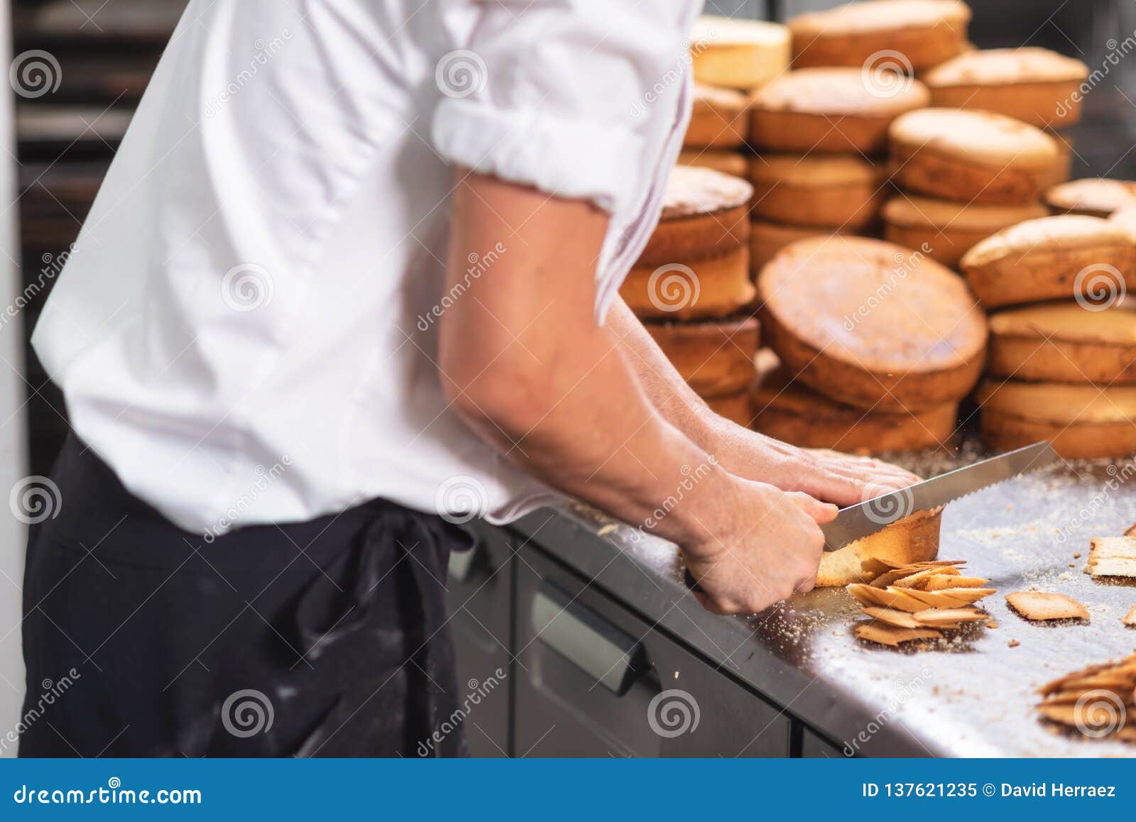 Pastry Chef Cutting the Sponge Cake on Layers. Cake Production Process ...