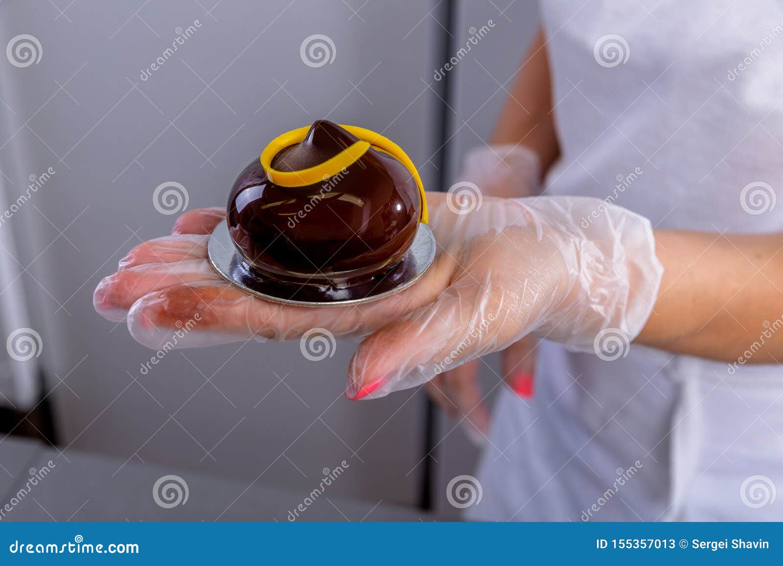 The Pastry Chef in the Kitchen Glazes Pastries. Cook Demonstrates a ...