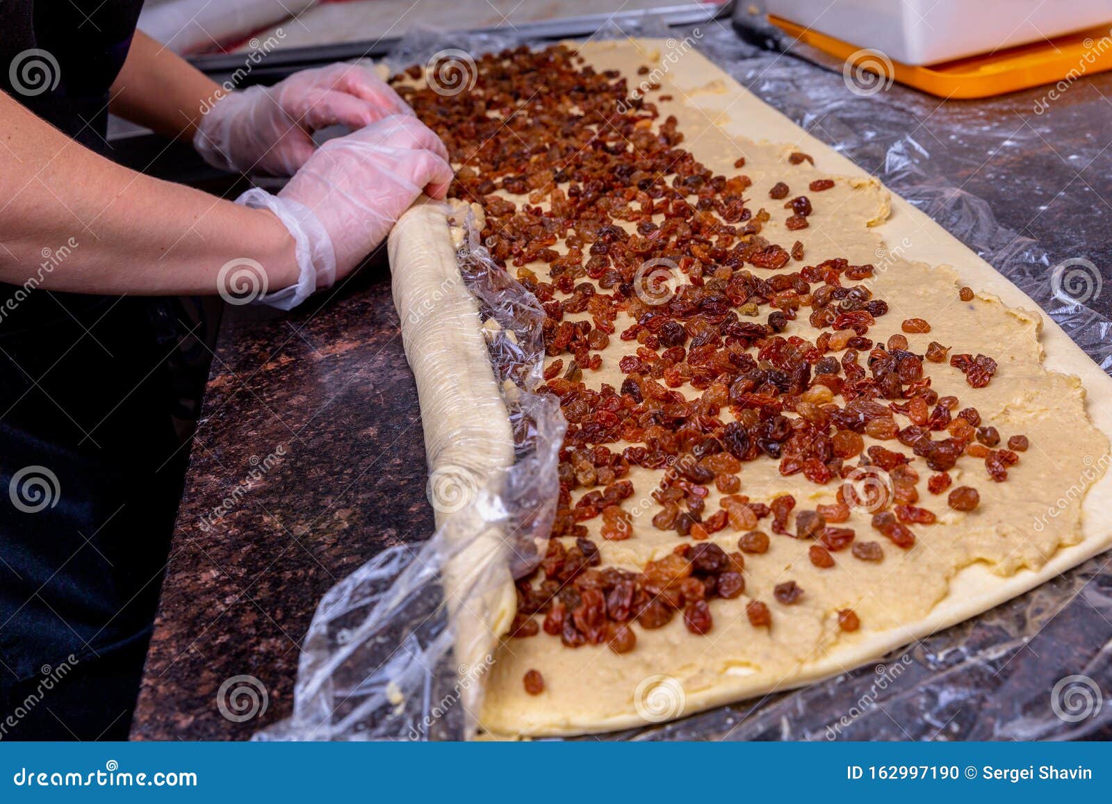 A Pastry Chef in the Kitchen is Making Pastries. Chef Wraps Dough with ...