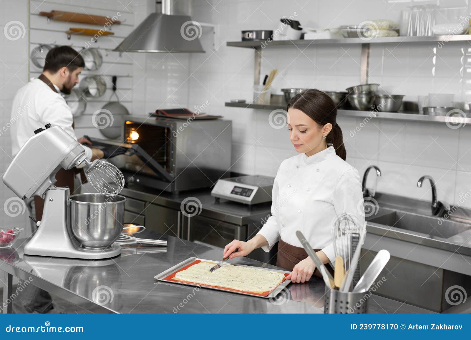 Pastry Chef Levels the Sponge Dough on Parchment before Baking Stock ...