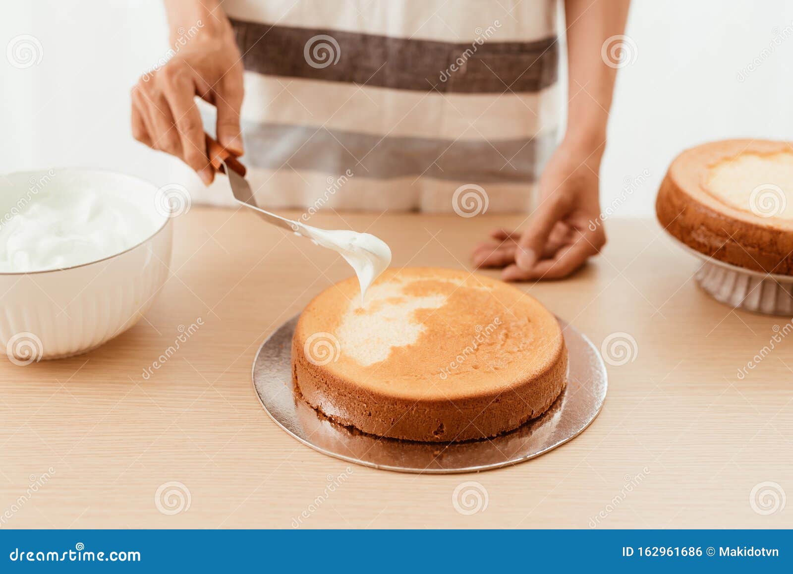 Pastry Chef Puts Cream on a Sponge Cake. Cake Making Process Stock ...