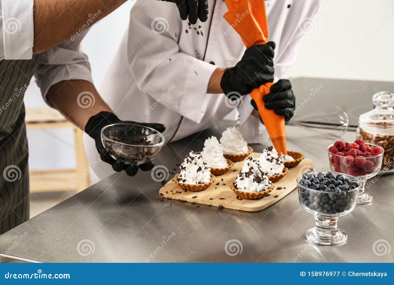 Pastry Chefs Preparing Desserts at Table in Kitchen Stock Image - Image ...