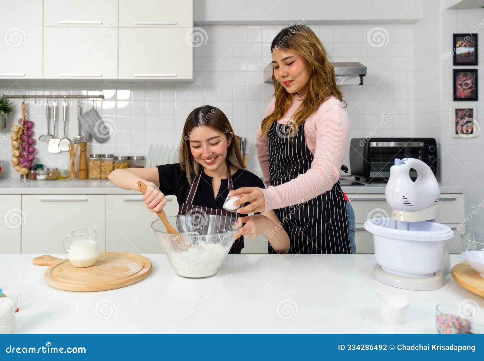 A Pastry Teacher Stands with Her Hand on Her Hip while Helping Her ...