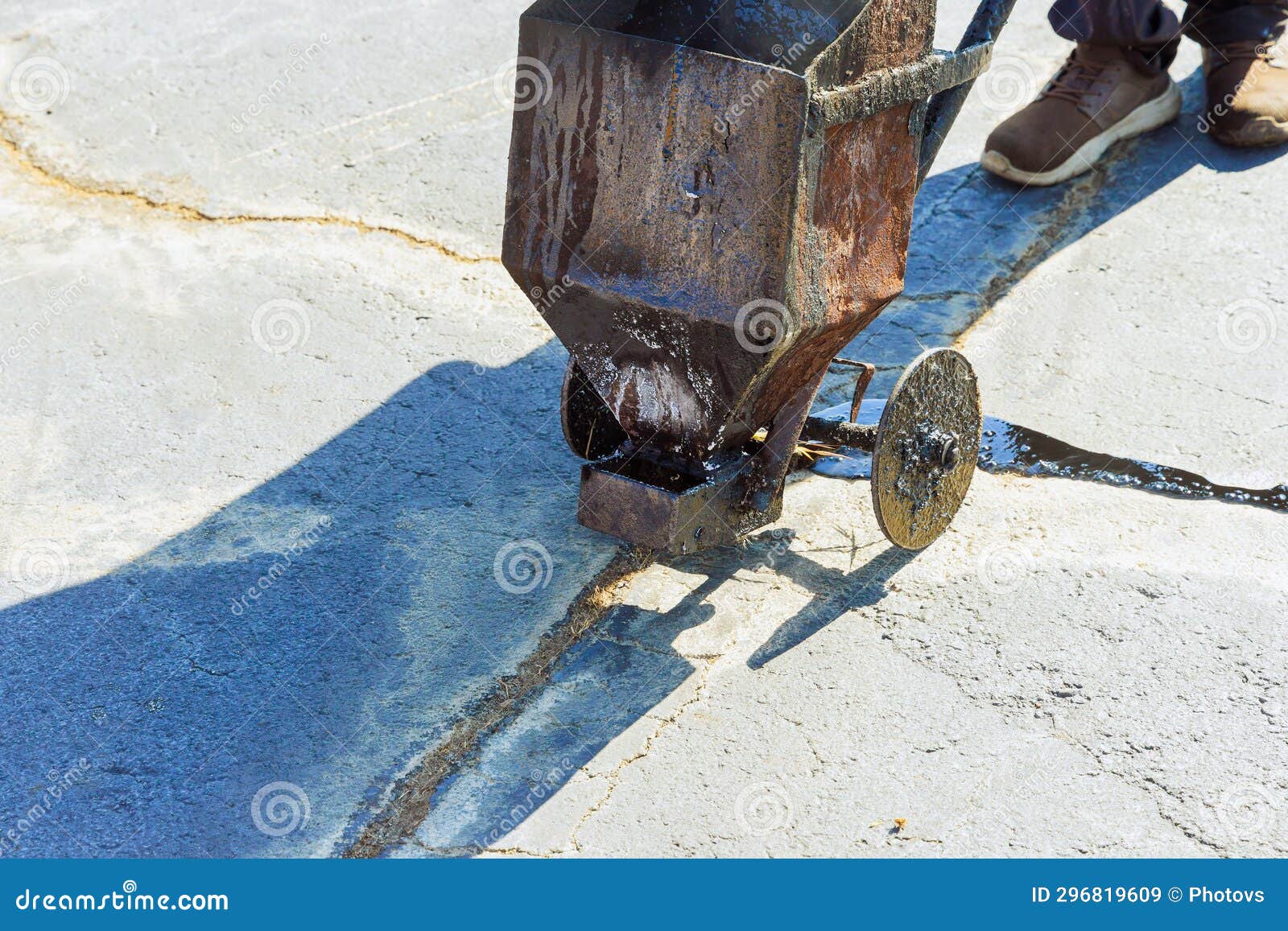Patcher Performs Work that Involves Coating Asphalt Cracks, Sealing ...