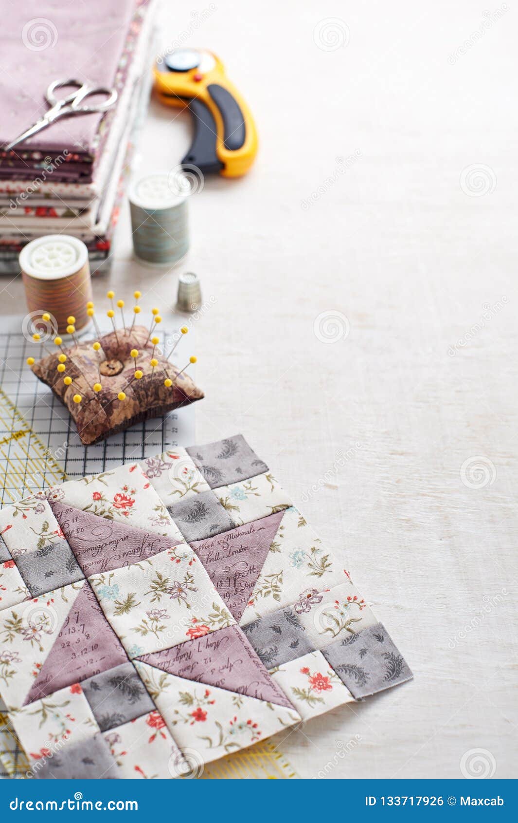 Patchwork Block on Craft Mat, Stack of Fabric, Sewing Accessories on ...