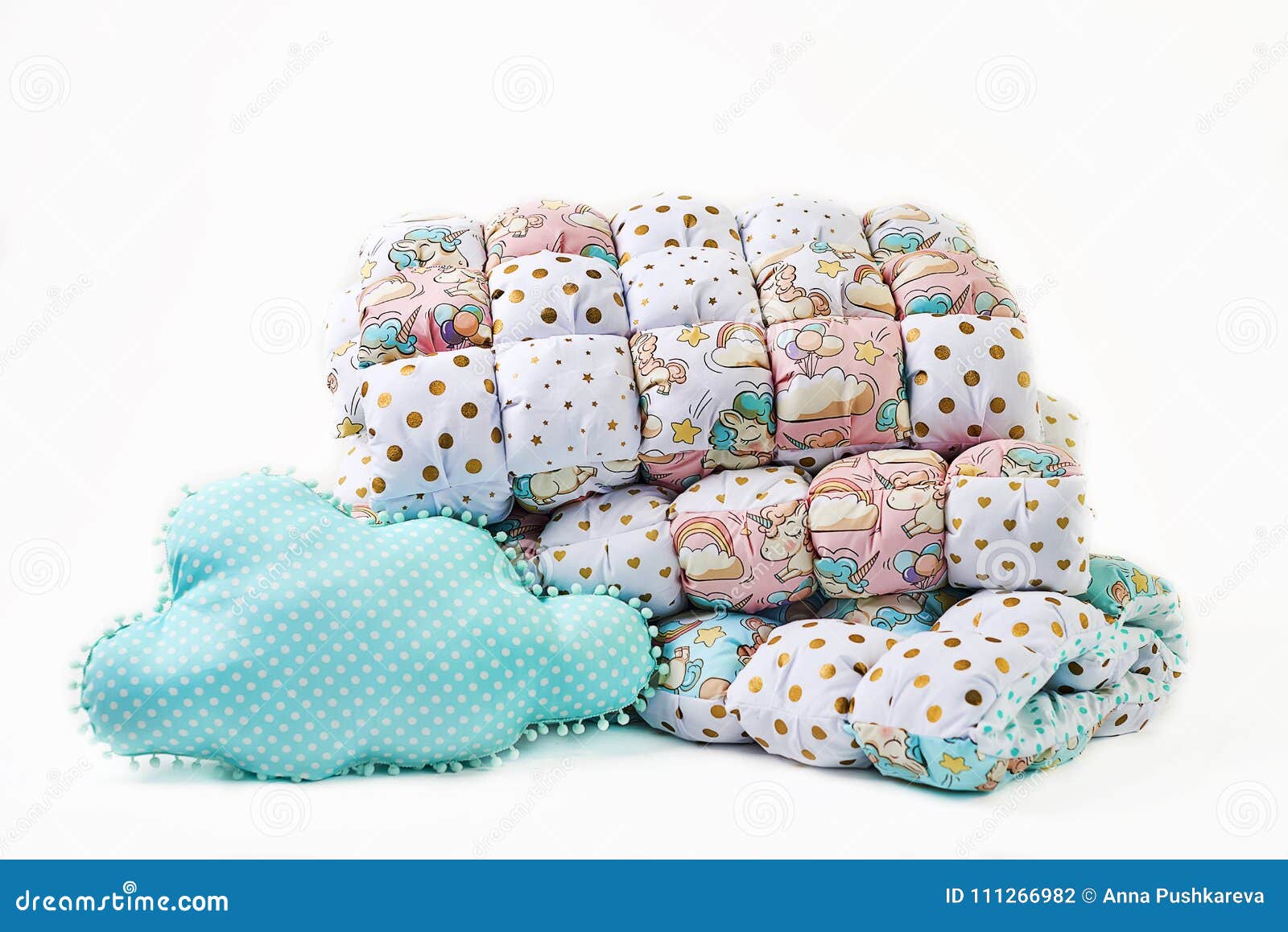 Patchwork Comforter and Cloud Shaped Blue Pillow on White Background ...