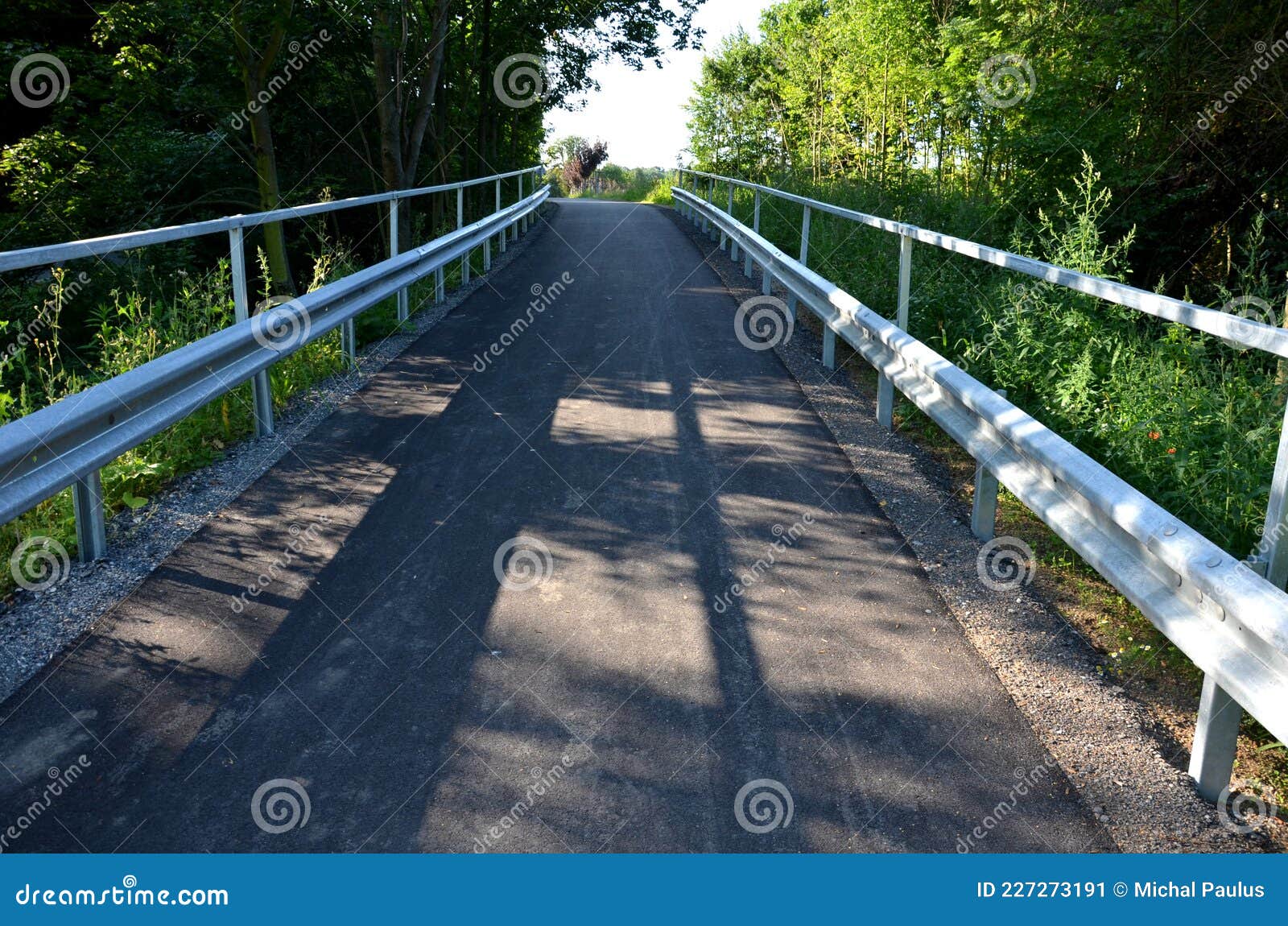 Path for Cyclists with an Asphalt Surface. Galvanized Iron Railing Over ...