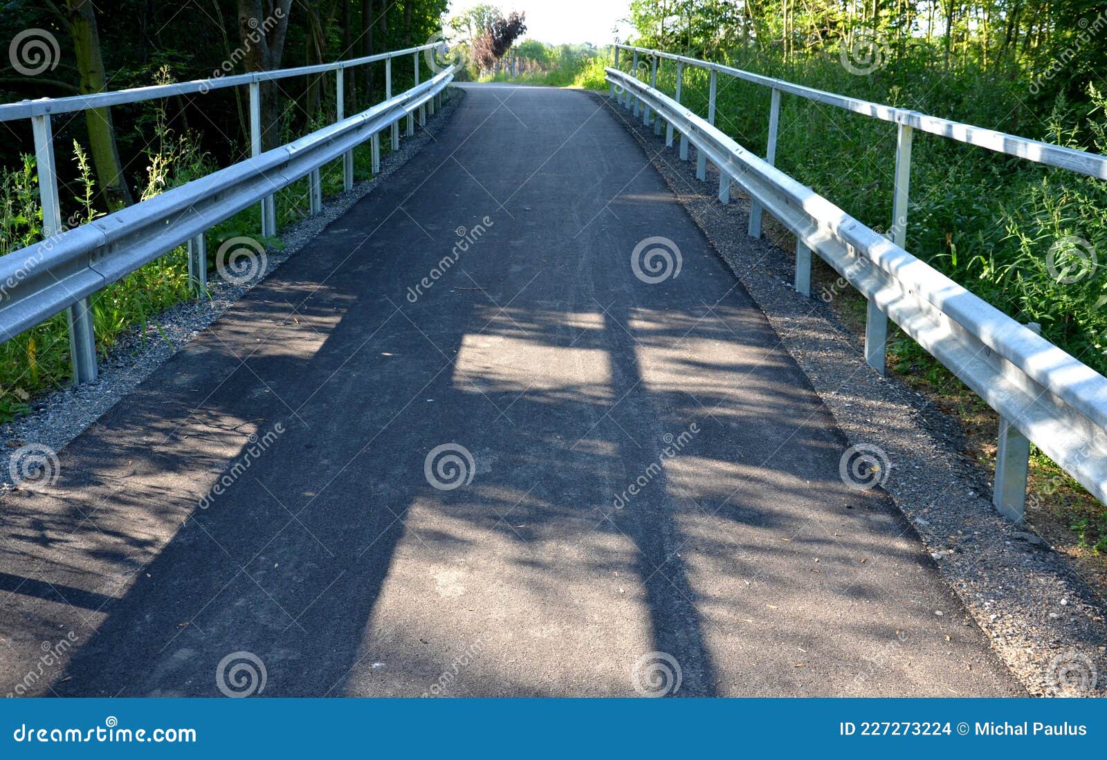 Path For Cyclists With An Asphalt Surface. Galvanized Iron Railing Over ...