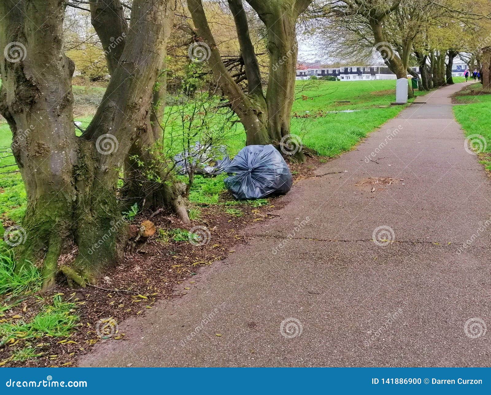 A Path Leading through a Park, a Litter Bag Has Been Discarded at the ...