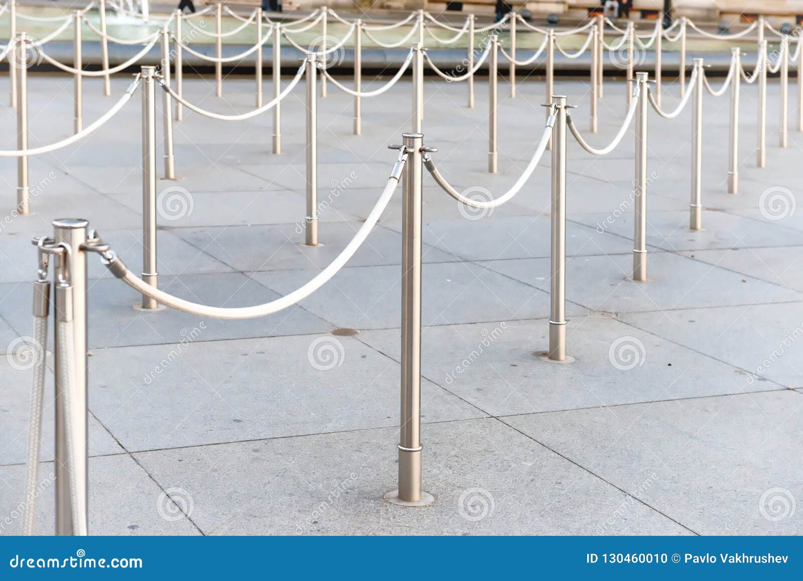 Path with Line of Silver Metal Poles Stock Photo - Image of fence ...