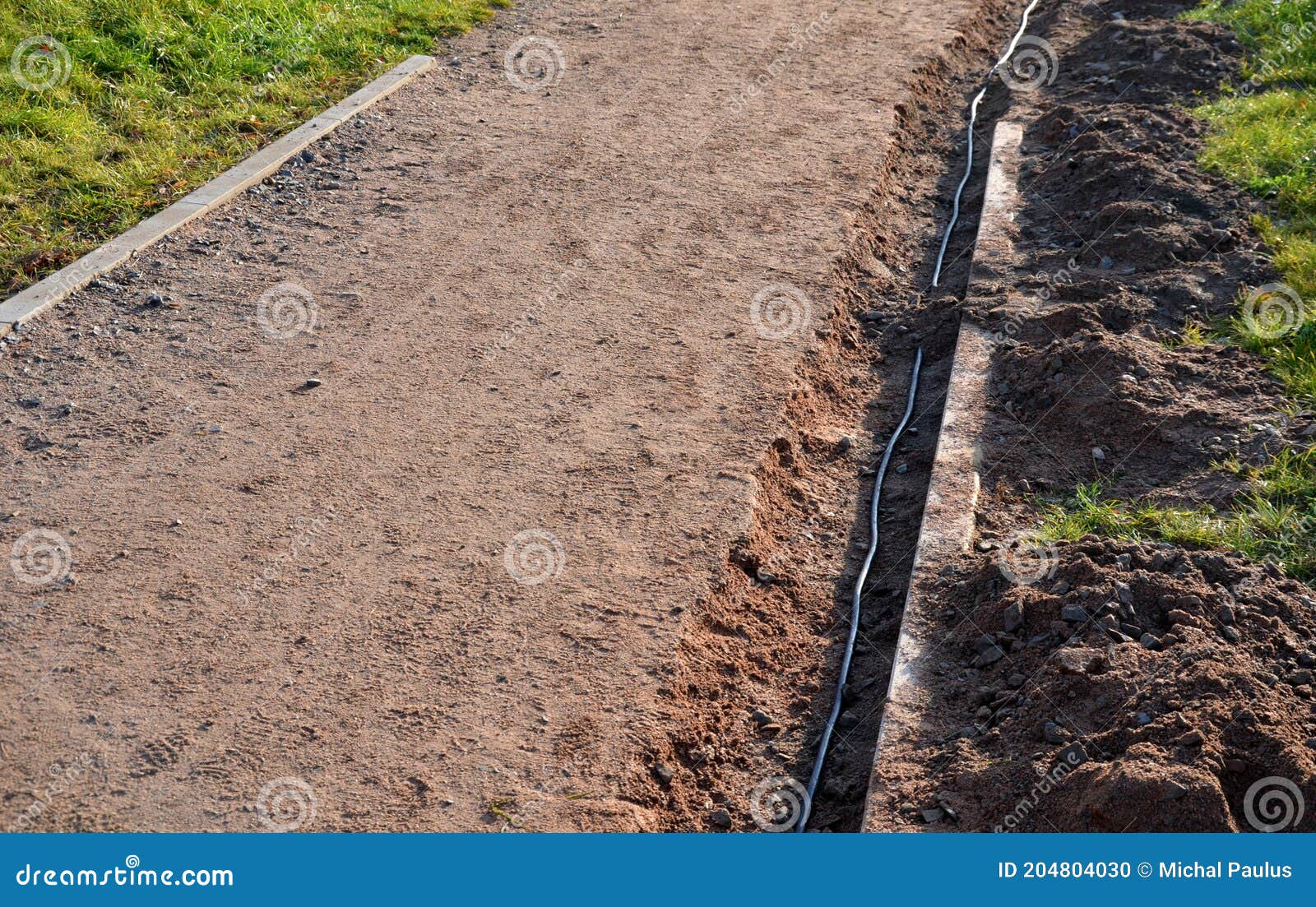 The Path in the Park is Interrupted by a Shallow Excavation of a Gutter ...
