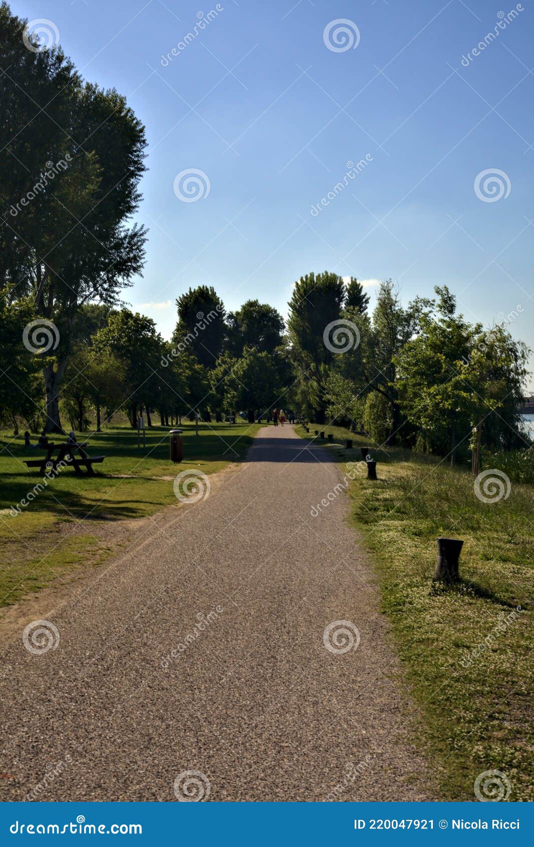 Path with People Walking by the Shore of a Lake on a Clear Day Stock ...